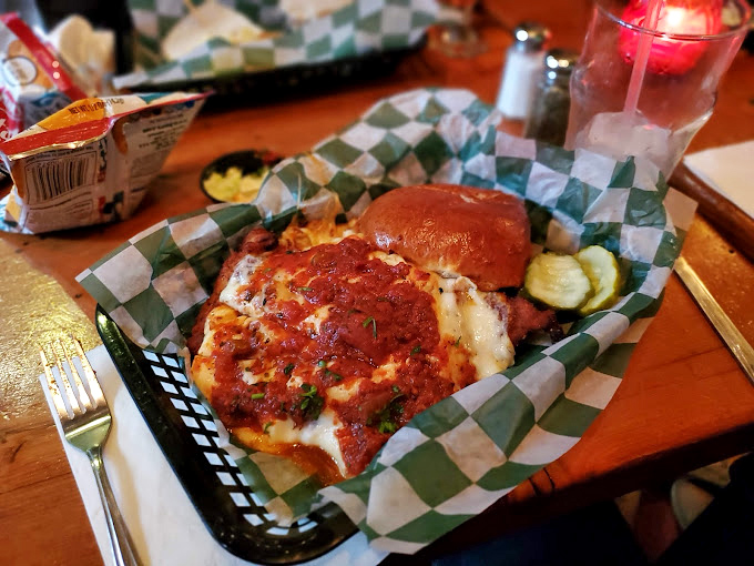 Chicken Parmesan that doesn't whisper "Italian-American classic" but belts it out like Rocky atop those famous steps, with melted cheese as its victory flag.