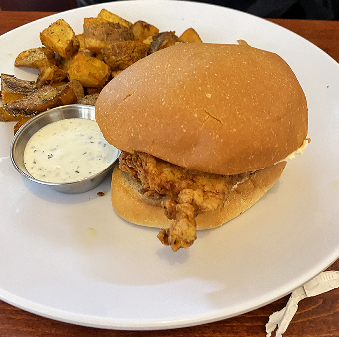 Fried chicken perfection meets pillowy bun in a sandwich that demands to be eaten with both hands and zero regrets.