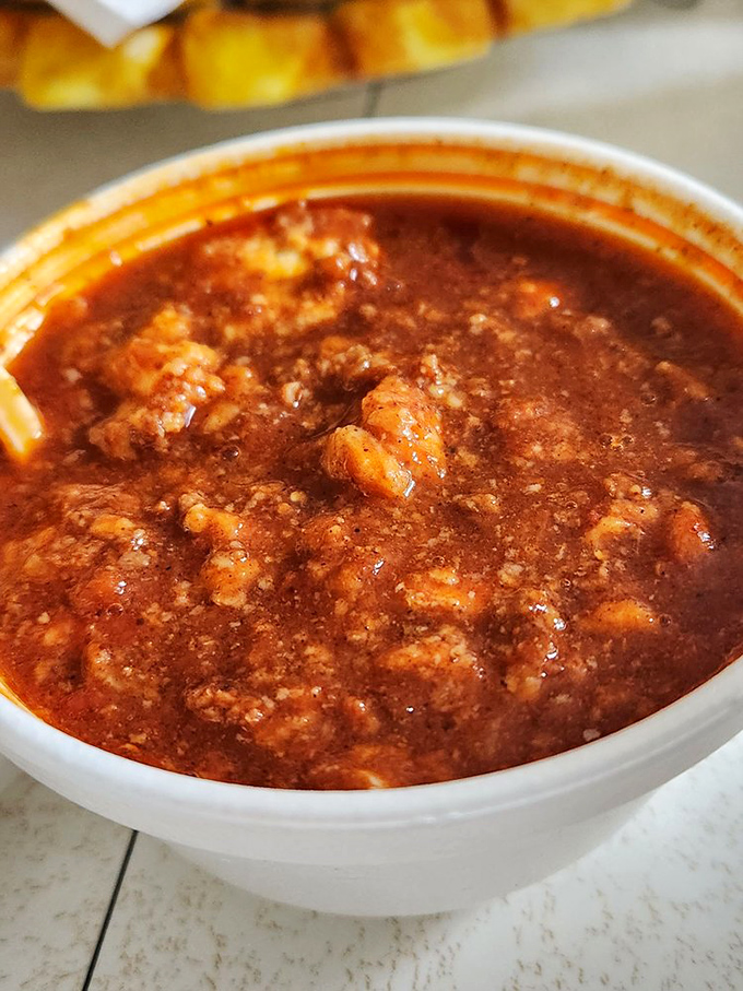 Hearty chili that looks like it's been simmering since breakfast, waiting patiently to become the highlight of someone's afternoon.
