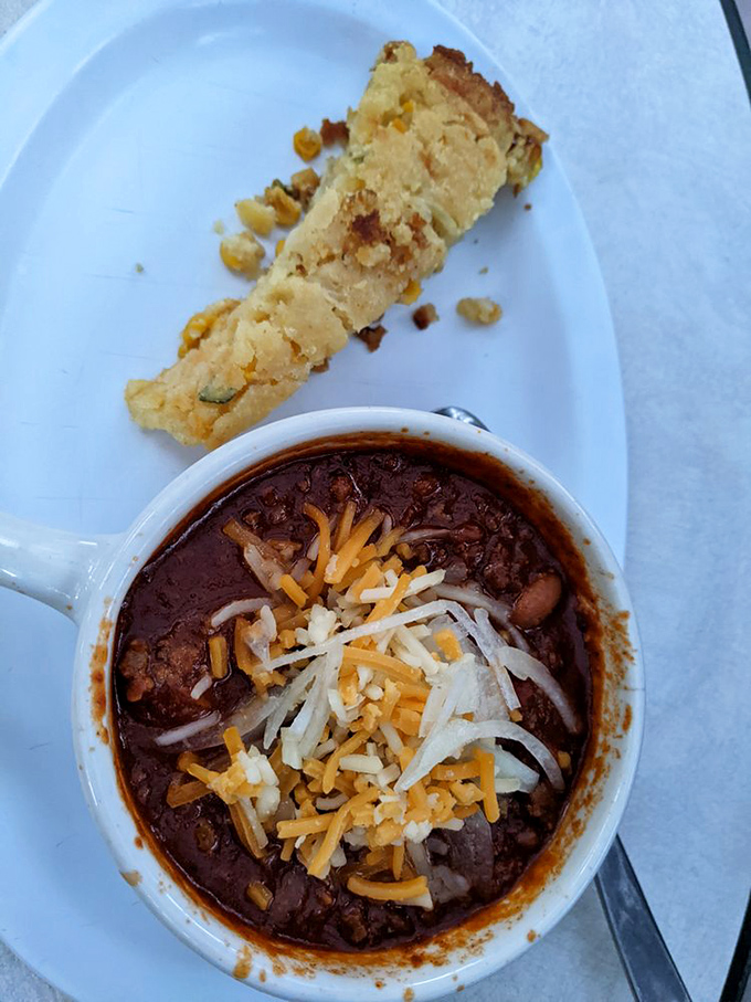 Hearty chili topped with melted cheese and a side of cornbread&mdash;desert comfort food that warms you from the inside out.