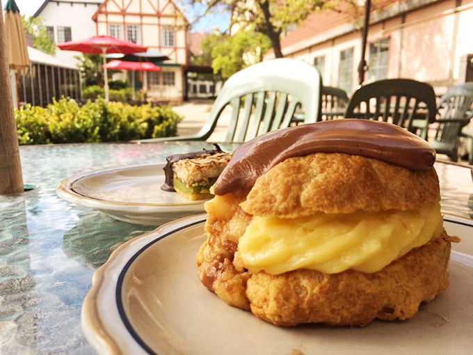 This chocolate-topped cream puff isn't just dessert&mdash;it's therapy in pastry form, with a custard filling that could solve international conflicts.