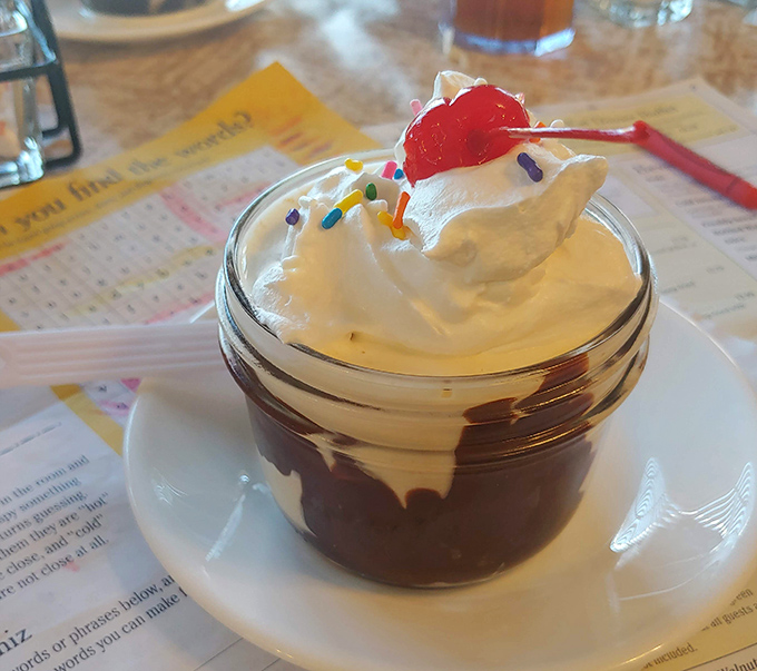 A chocolate sundae that understands the importance of proper whipped cream-to-chocolate ratio. That cherry on top isn't garnish—it's the exclamation point.