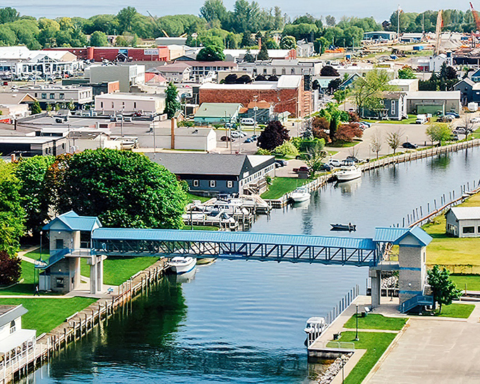 The river cuts through Cheboygan like nature's Main Street, with the iconic footbridge connecting not just shores but generations of local history.