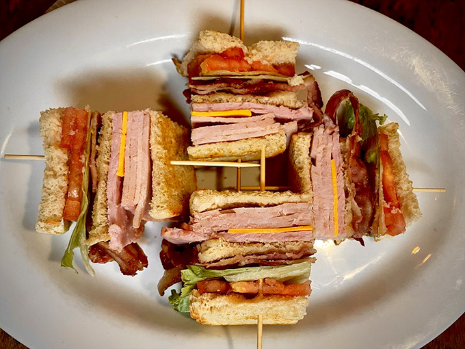 The club sandwich towers like a delicious skyscraper of bacon, lettuce, and tomato engineering.