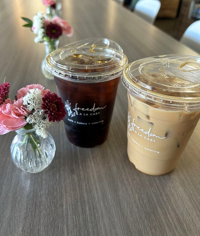 Coffee served with flowers—because caffeine should be beautiful too. That cold brew looks dark enough to jumpstart a Monday or fuel a dissertation.