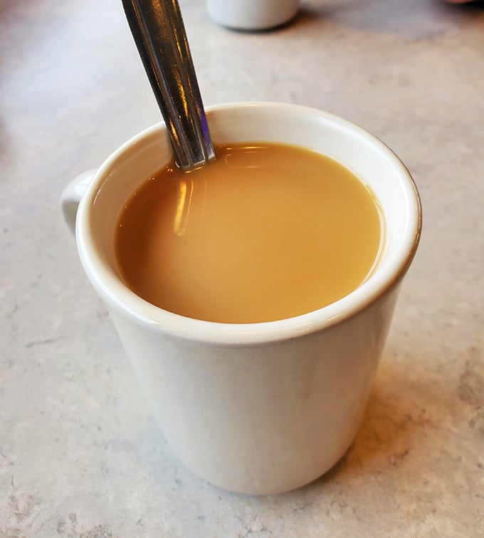 The humble diner coffee cup—civilization's greatest achievement. Not fancy, not pretentious, just reliable warmth in ceramic form.