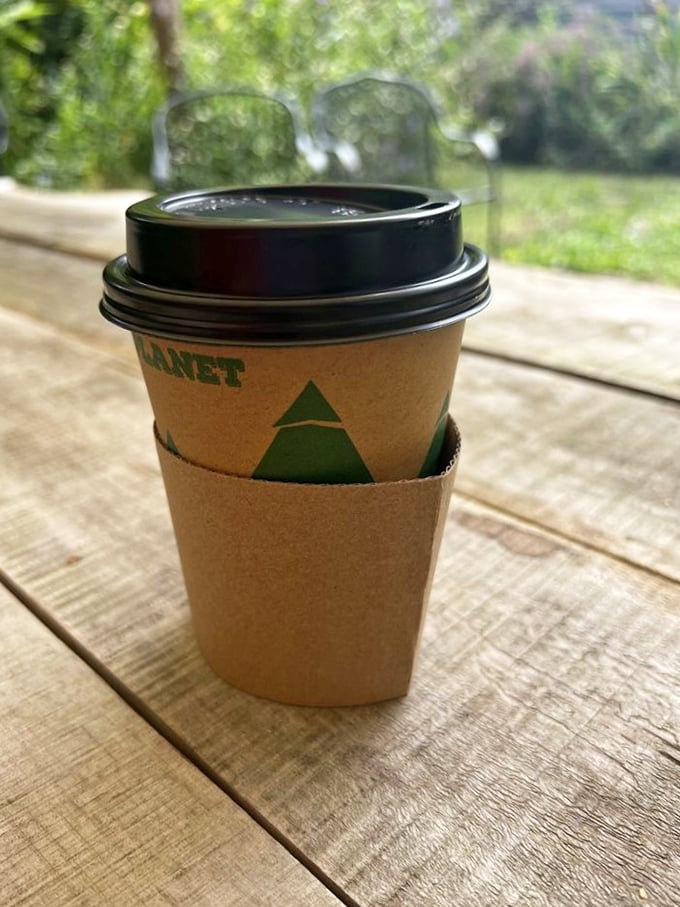 Coffee on the porch: a simple pleasure elevated to art form. The eco-friendly sleeve isn't just holding your cup&mdash;it's hugging the planet too.