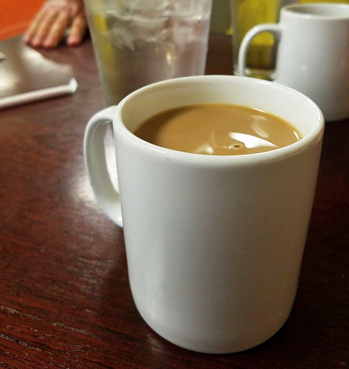 The humble white mug&mdash;civilization's perfect delivery system for life-giving coffee. At Ray's, refills appear like magic, keeping breakfast dreams alive.