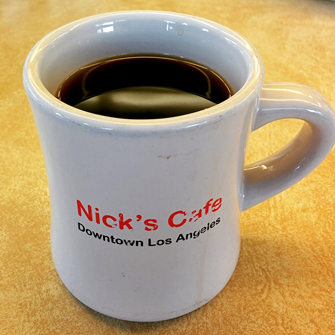 That classic diner mug—slightly imperfect, wonderfully sturdy—holding what might be the lifeblood of Los Angeles: strong, honest coffee that doesn't need a fancy Italian name.