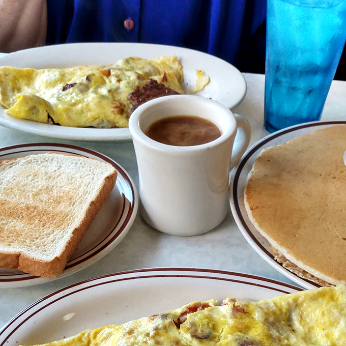 The breakfast spread that dreams are made of&mdash;golden omelets, buttery toast, steaming coffee, and pancakes that make you question whether you should even attempt to finish them.