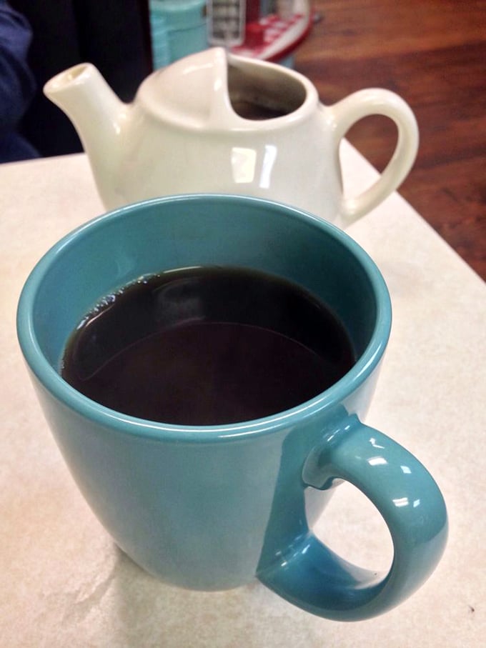 That turquoise mug isn't just serving coffee&mdash;it's delivering liquid motivation in a color that matches the diner's soul. The individual pot is pure diner luxury.