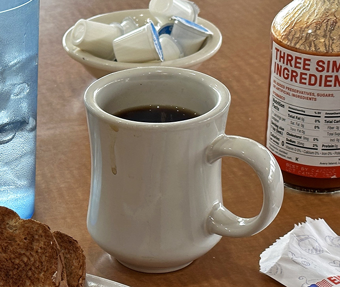 The humble white diner mug&mdash;civilization's perfect coffee delivery system. No fancy handles or artisanal glazes, just reliable caffeine transport.