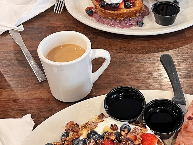 Coffee served in sturdy mugs that say "we're not messing around," alongside fresh fruit that didn't come from a can.