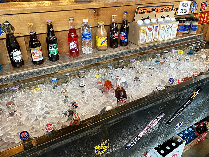 The drink station—where vintage bottles meet modern thirst—offers a frosty intermission between bites of smoky, saucy goodness.