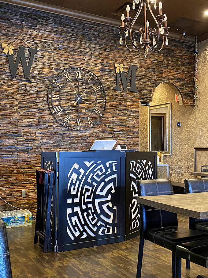 The host station features intricate geometric designs that hint at the cultural journey awaiting diners. Stone walls and elegant lighting set the stage for culinary magic.