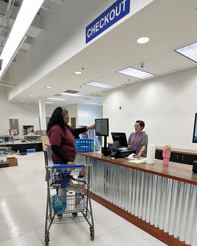 Fellow treasure hunters navigating the aisles with the focused determination of seasoned bargain archaeologists.
