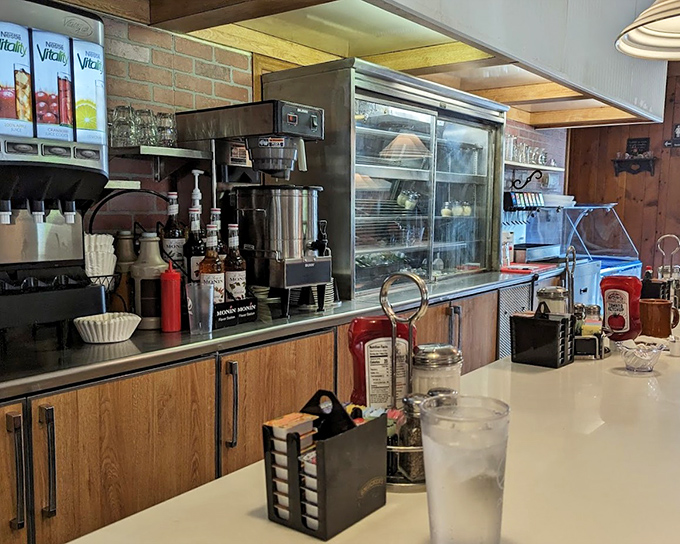 The beating heart of diner operations: where coffee flows freely and pie dreams come true. That classic counter setup has witnessed more local news than the town paper.