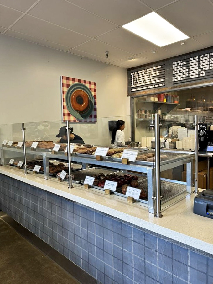 Donut diplomacy happens here daily. The glass case serves as both display and torture device for the indecisive.