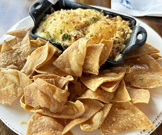 This crab and artichoke dip isn't just an appetizer&mdash;it's the opening act that threatens to upstage the headliner. Those chips are merely vehicles for greatness.