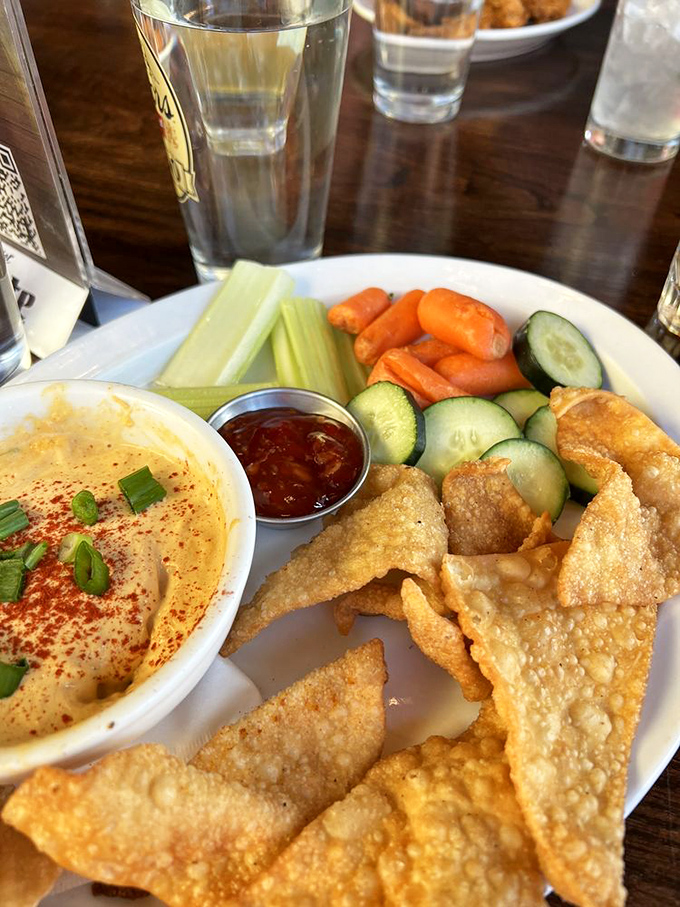 Dip nirvana: Creamy hummus, crispy wonton chips, and fresh veggies create the kind of appetizer that disappears before anyone admits to having seconds.