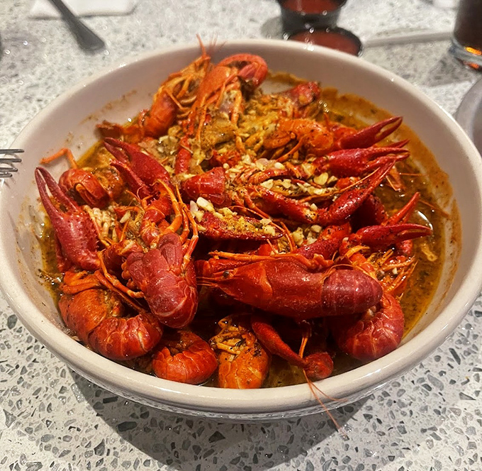 Crawfish that look like they're having a pool party in spices. The kind of dish that justifies keeping an extra napkin tucked in your collar.