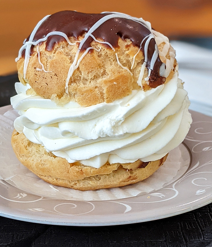 This cream puff doesn't just have layers, it has a storyline&mdash;crisp pastry, billowing cream, and a chocolate-drizzled finale that deserves a standing ovation.