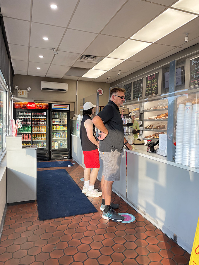 The universal language of anticipation: customers patiently waiting their turn, knowing that good things come to those who queue at Yum Yum.