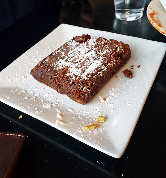 This chocolate dessert isn't playing around. That dusting of powdered sugar is like the final note in a symphony of sweetness.
