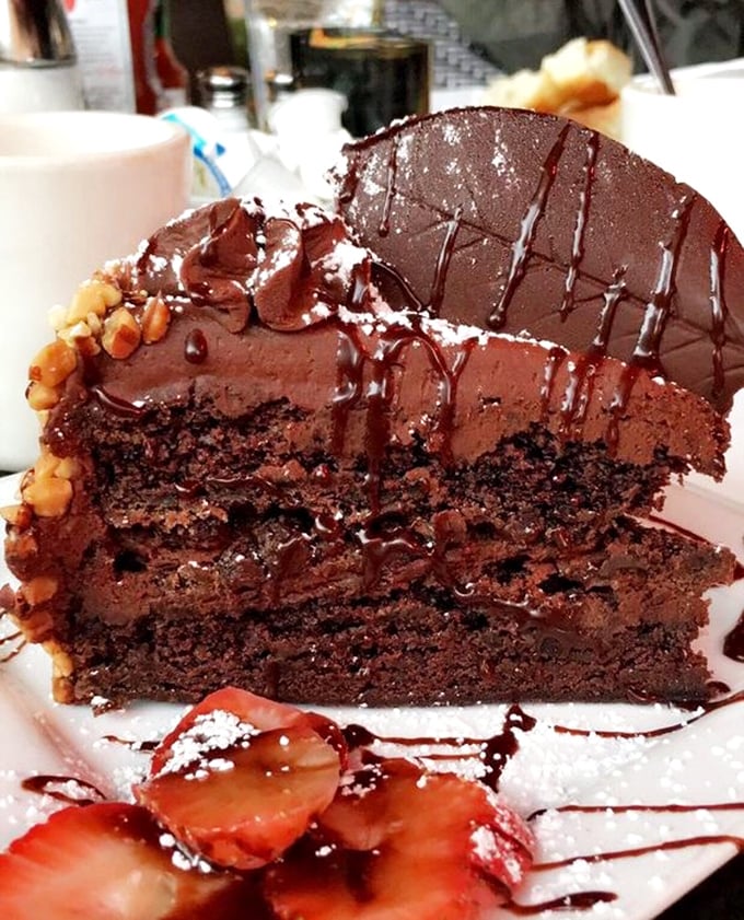 Chocolate cake so decadent it should require a permission slip. Those layers aren't just dessert; they're therapy with a fork.