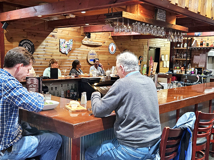 Local diners gather at the welcoming bar, sharing stories over exceptional food and cold beverages.