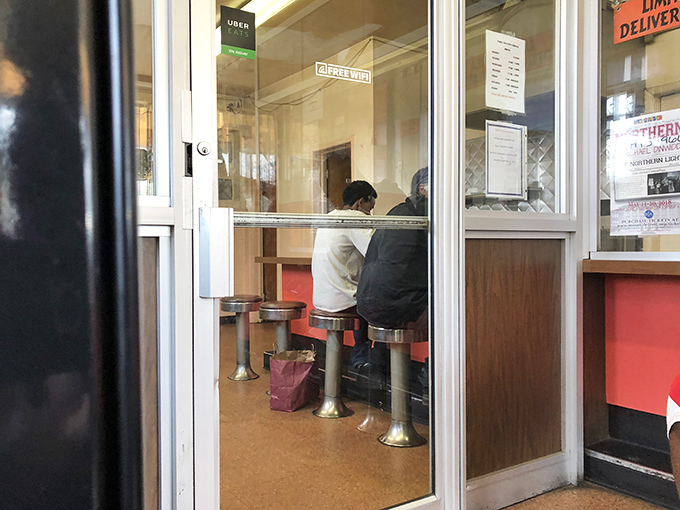 The universal language of BBQ anticipation &ndash; watching through the glass as your order comes together is better than any cooking show.
