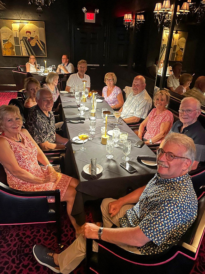 Happy diners gathered around a table laden with possibilities. This is what restaurants are really about&mdash;connection over exceptional food.
