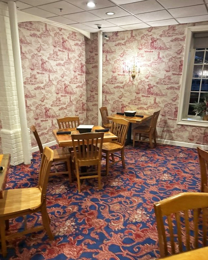 Toile wallpaper and wooden chairs create dining nooks that feel like you've stepped into a maritime novel&mdash;with better food and fewer shipwrecks.