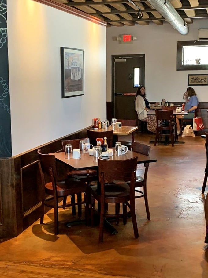 Simple wooden tables, white walls, and warm lighting create the perfect canvas for breakfast conversations that stretch lazily into the afternoon.