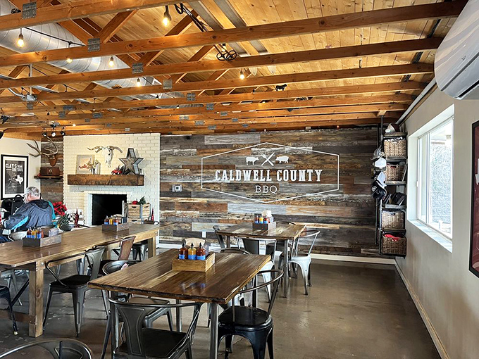 Industrial meets rustic in this dining space where serious eating happens. The logo wall silently promises delicious things while wooden tables await their meaty burden.