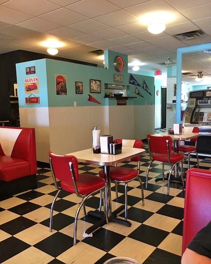 The dining area balances nostalgia with comfort &ndash; turquoise walls, vintage car photos, and booths that have cradled countless conversations and coffee refills.