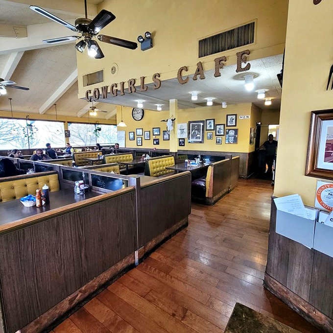 The dining area's yellow walls, wooden booths, and vintage signage create that rare atmosphere where strangers become neighbors over coffee refills.