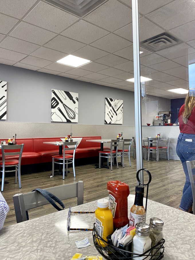 Red booths against metallic accents create that perfect diner aesthetic—not trying too hard to be retro, not coldly contemporary. Just right.