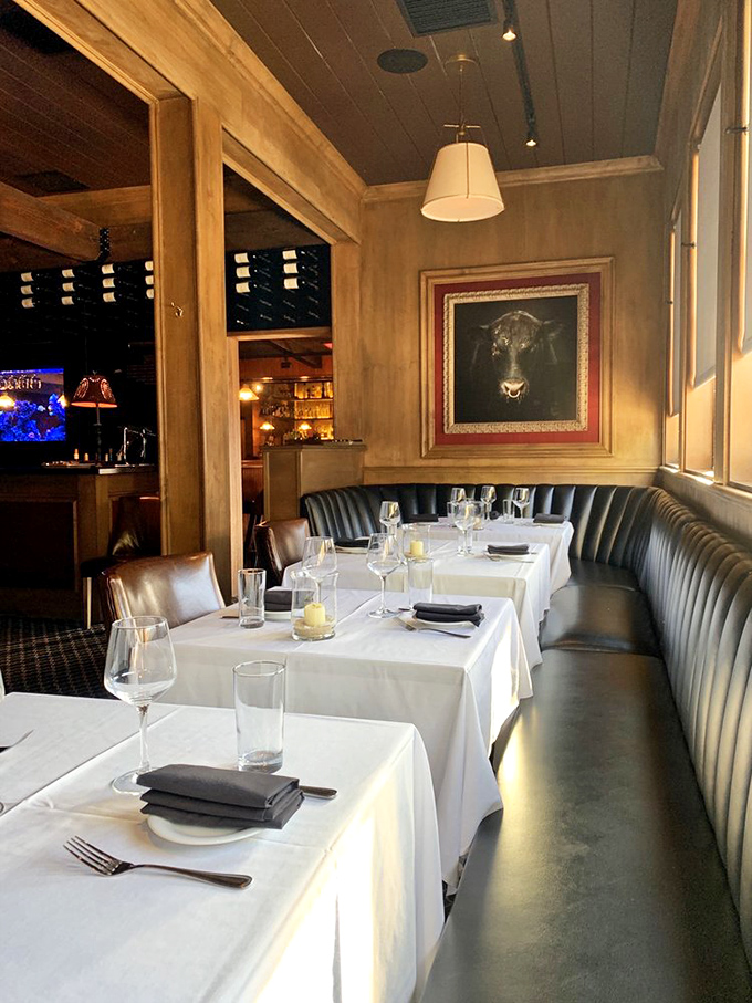 White tablecloths meet leather banquettes in a dining room where deals are sealed and anniversaries celebrated. Note the bull artwork standing guard.