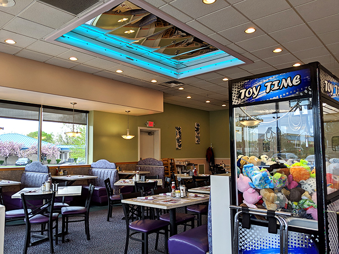 A dining room where memories are made between coffee refills. That claw machine in the corner has witnessed more family negotiations than a holiday dinner table.