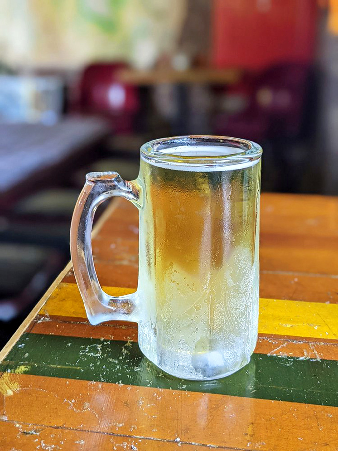 A frosty mug of beer sits expectantly on a colorful table &ndash; the perfect silent partner to fried chicken's boisterous personality.