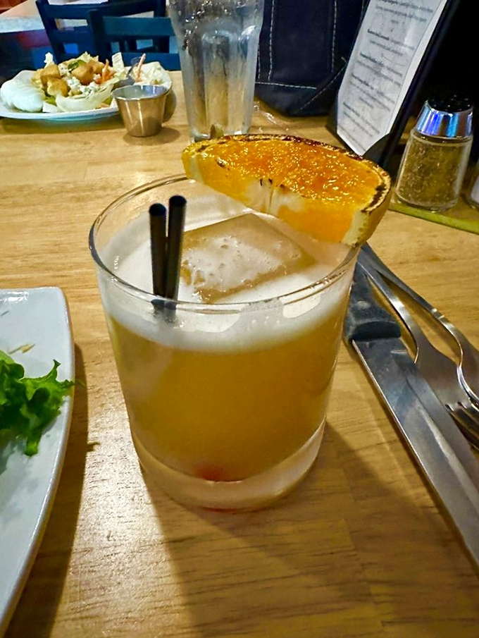 This isn't just a cocktail&mdash;it's liquid sunshine with a caramelized orange garnish. The kind of drink that makes you forget about your inbox for a while.