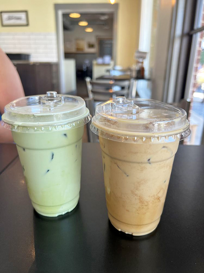 Two iced coffees having a conversation about which one you'll fall in love with first—the matcha-tinted green or the classic caramel-hued brew.