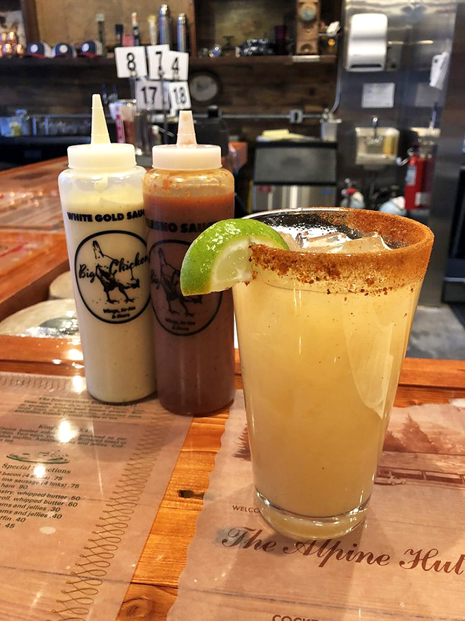 The holy trinity of refreshment: White Gold sauce, Inferno sauce, and what appears to be a margarita. Choose your adventure wisely, friends.