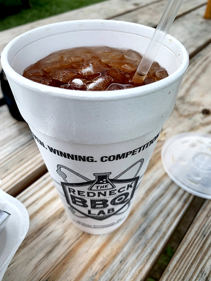 Sweet tea served in its natural environment&mdash;a branded cup on a wooden picnic table. The unofficial wine pairing for all things smoked.