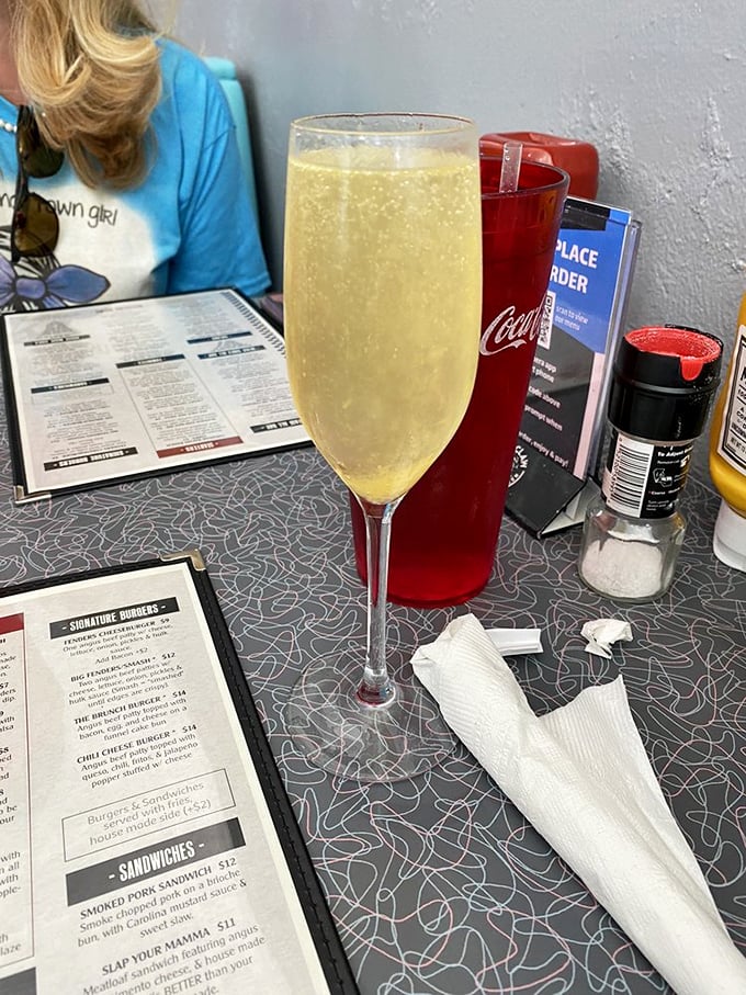 Bubbles rising in a champagne flute next to well-worn menus &ndash; because sometimes Tuesday deserves to dress up as Saturday night.