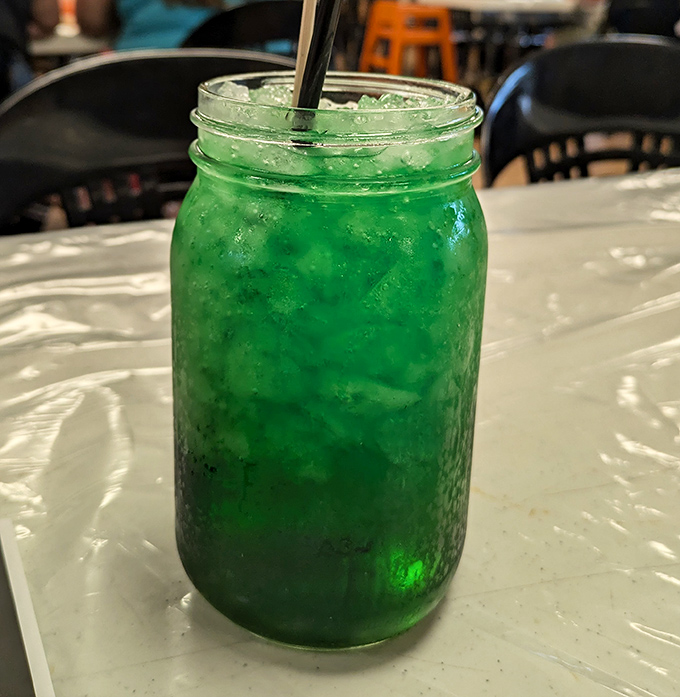 That electric green concoction isn't just a drink, it's vacation in a mason jar – refreshing proof you're officially on coastal time.