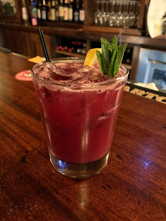 Not just a cocktail, but a ruby-hued work of art, garnished with fresh mint and lemon—liquid vacation in a glass.