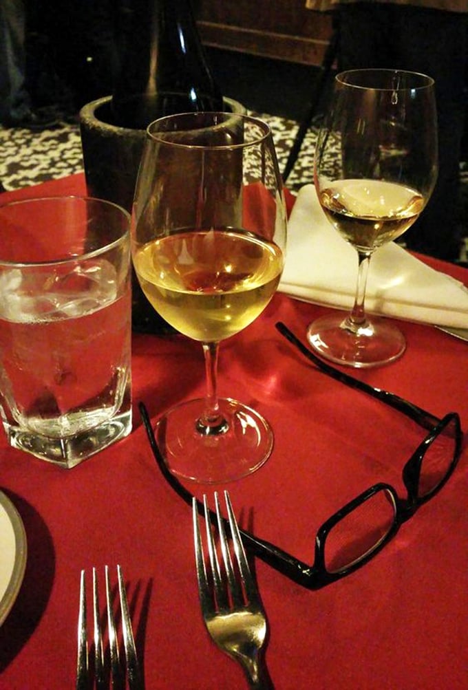 Wine glasses catching the light on a red tablecloth&mdash;the universal signal that good decisions are being made and memorable conversations are about to begin.