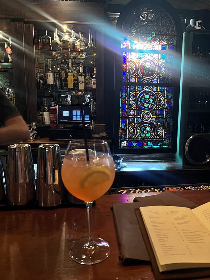 The bar's stained glass window catches light like a cathedral of cocktails. Spiritual experiences guaranteed.
